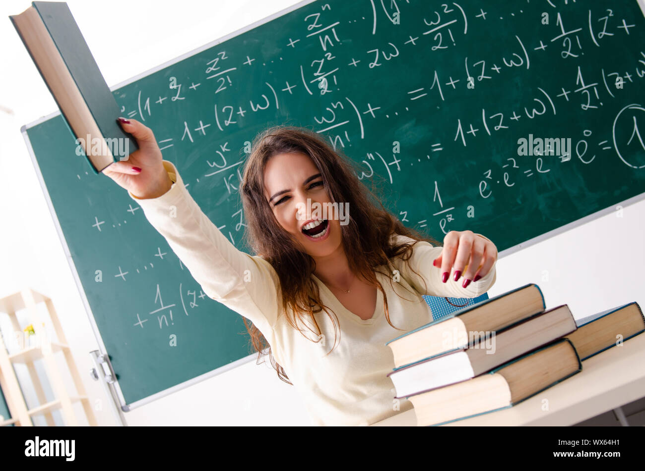 Young female math teacher in front of chalkboard Stock Photo - Alamy