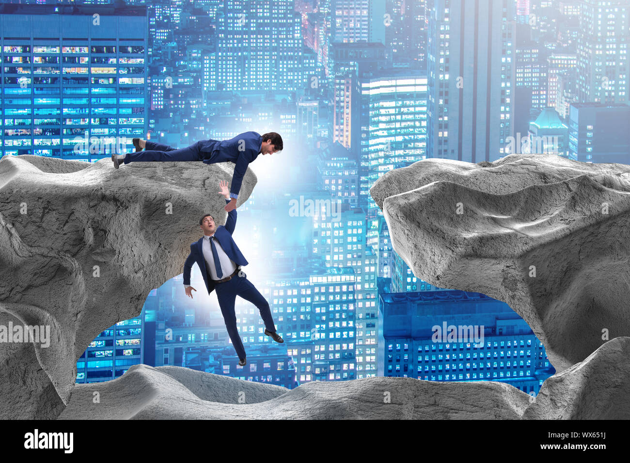 Businessman offering helping hand to falling colleague Stock Photo - Alamy