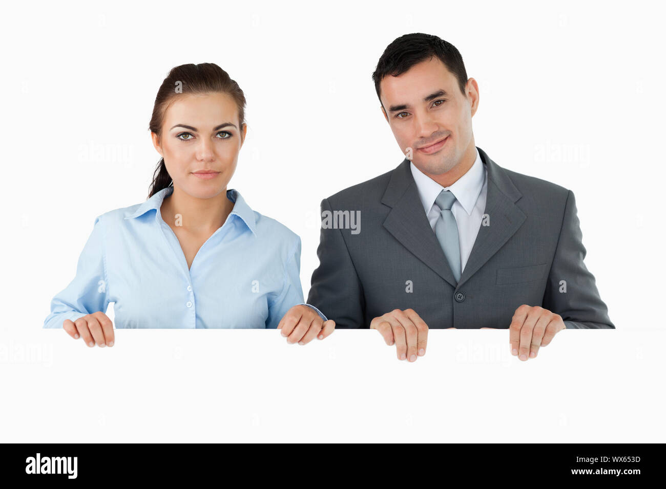 Business partners holding sign against a white background Stock Photo ...