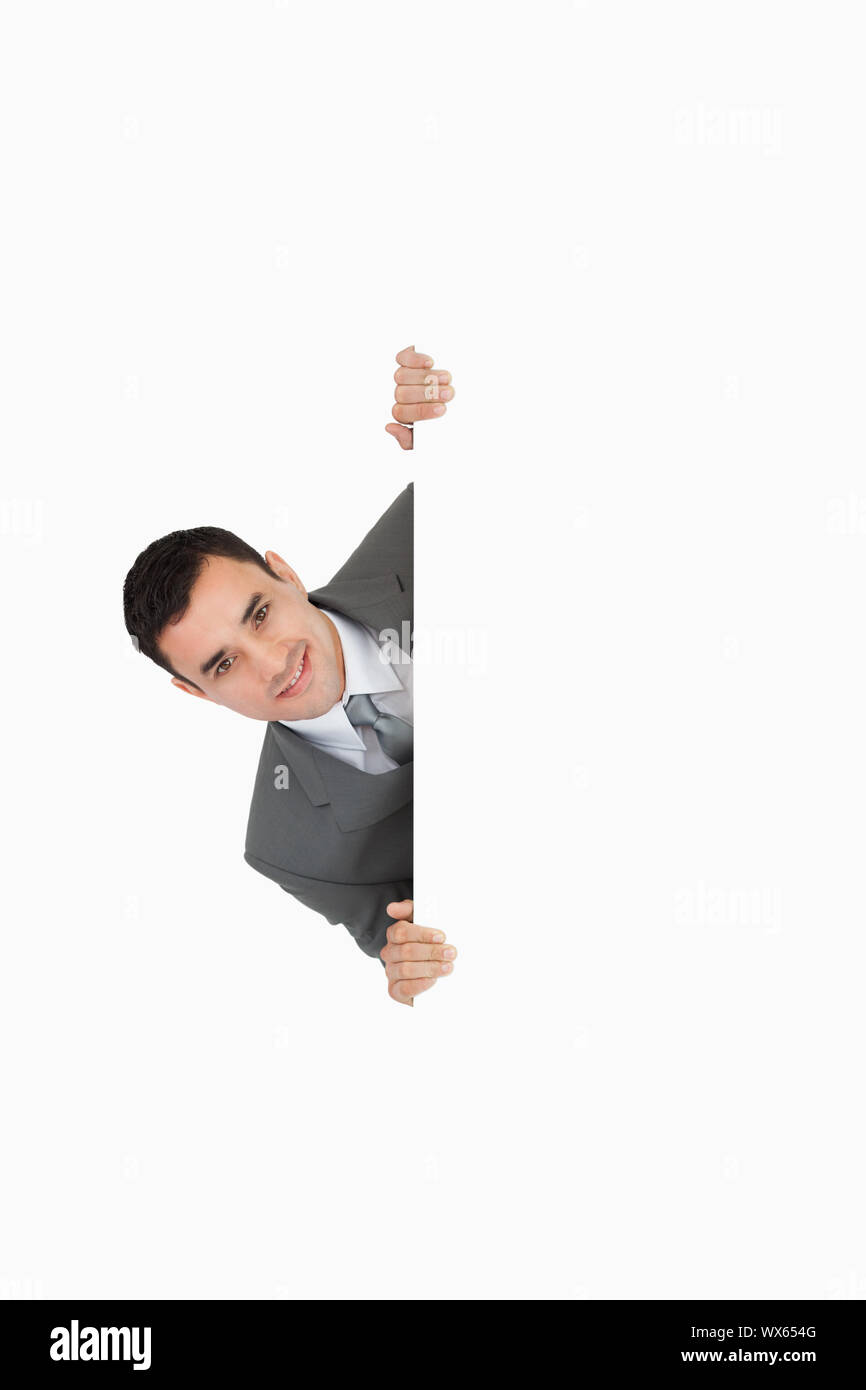 Businessman sneaking around the corner on white background Stock Photo ...