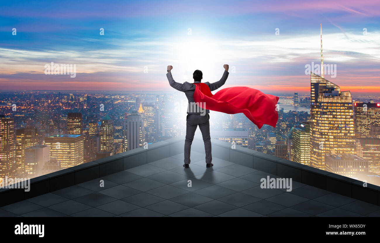 Superhero businessman on top of building Stock Photo - Alamy