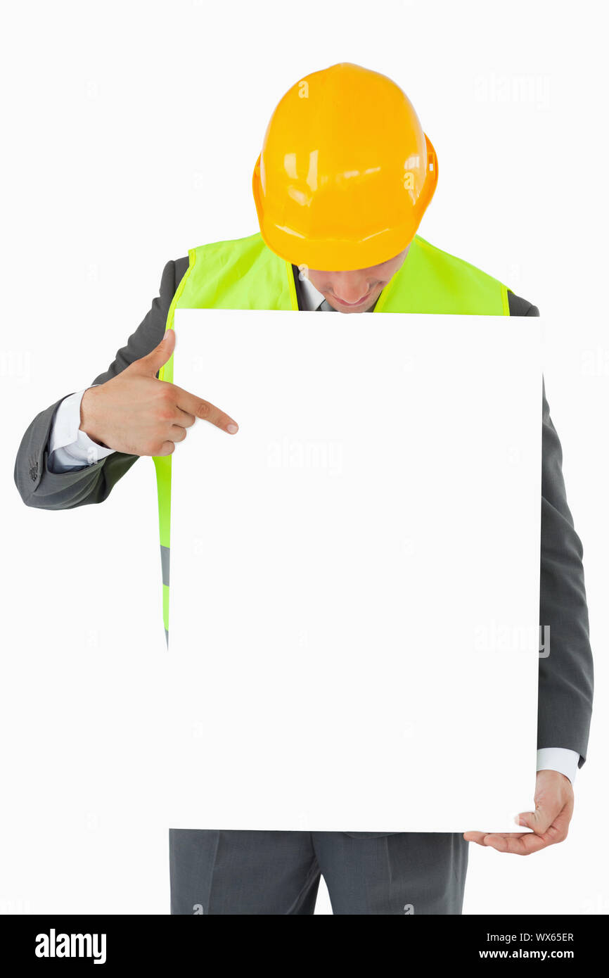 Architect looking and pointing on sign in his hands against a white ...