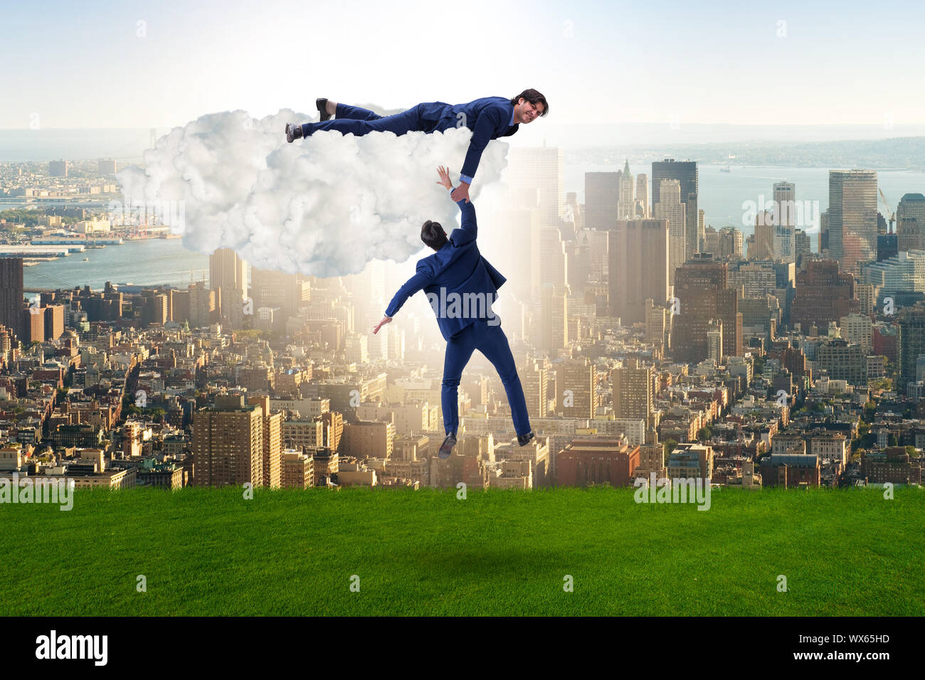 Businessman offering helping hand to falling colleague Stock Photo - Alamy