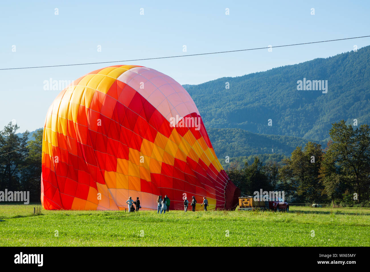 Hot air balloon being deflated after taking tourists on a flight over ...