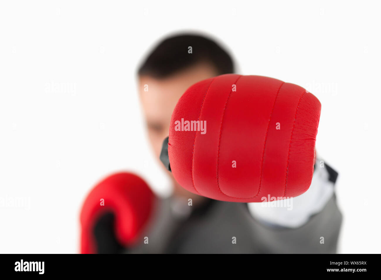 Close up of boxing glove being used to slam by businessman against a ...