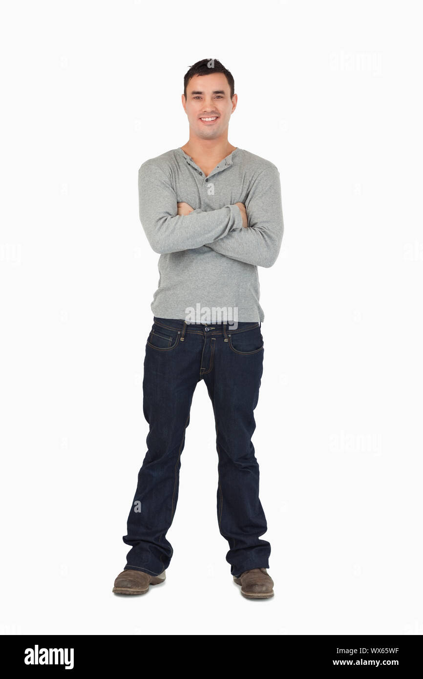 Young male standing with arms folded against a white background Stock ...