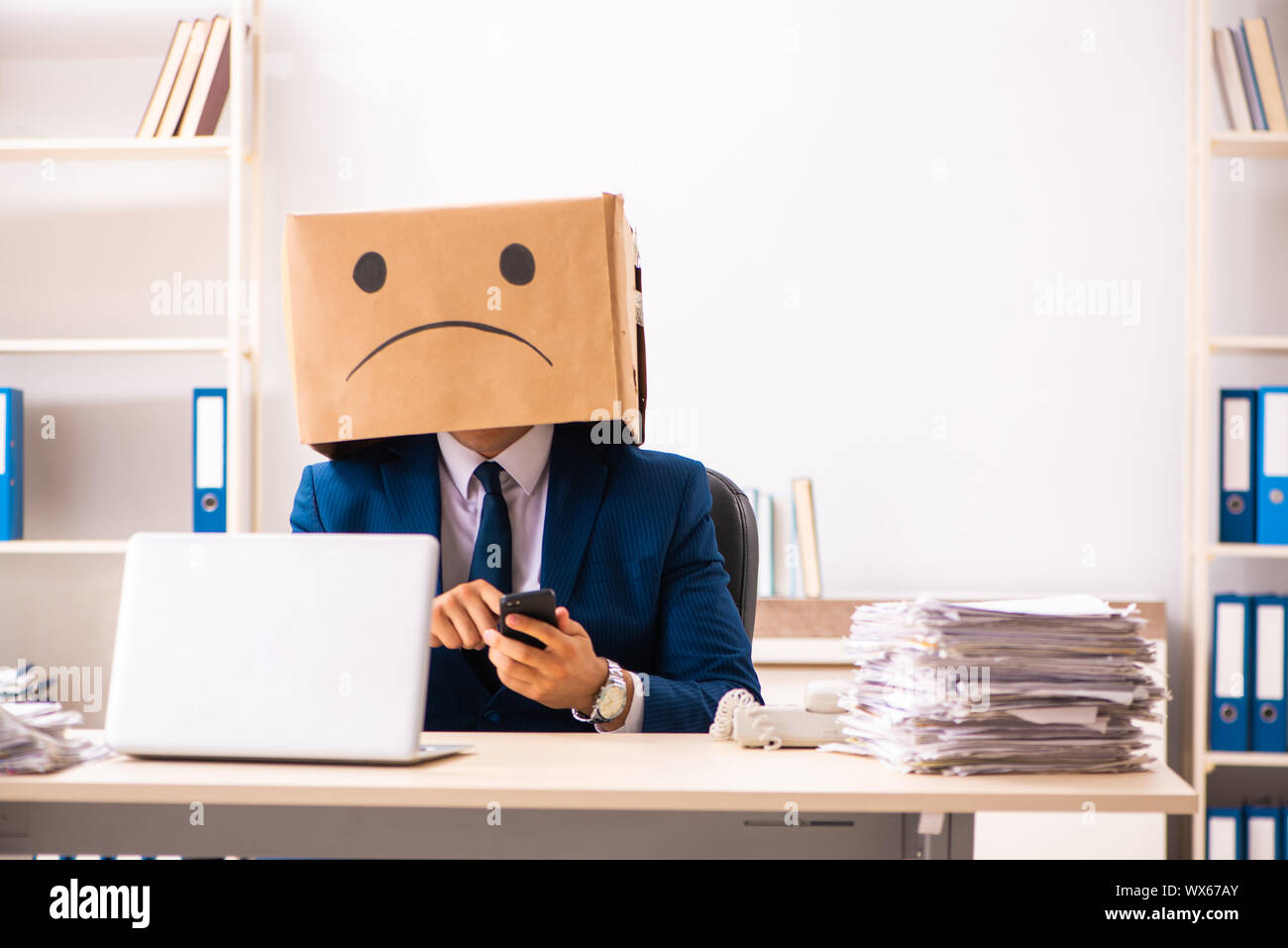 Unhappy man employee with box instead of his head Stock Photo - Alamy