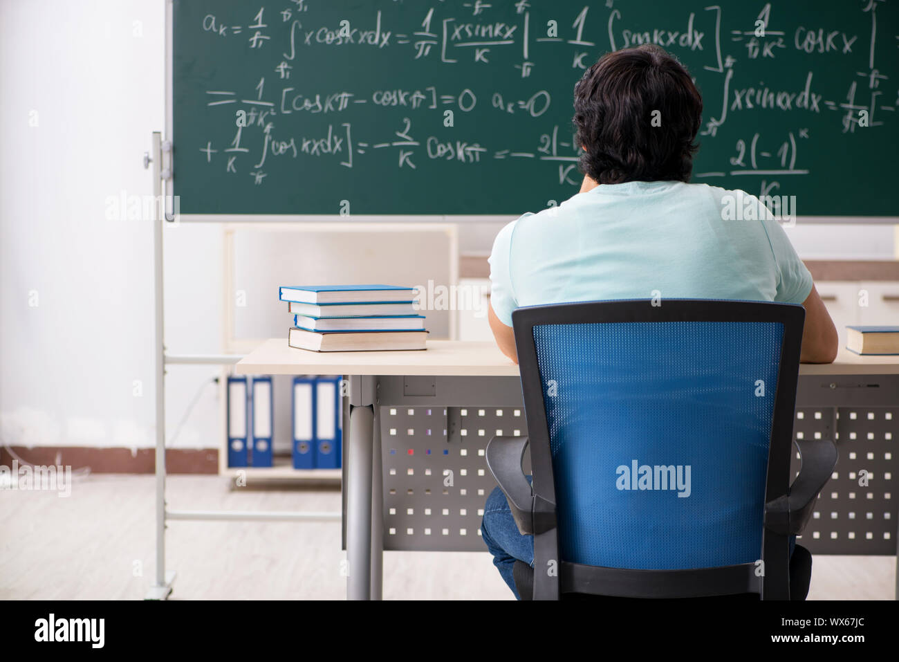 Young male student mathematician in front of chalkboard Stock Photo - Alamy