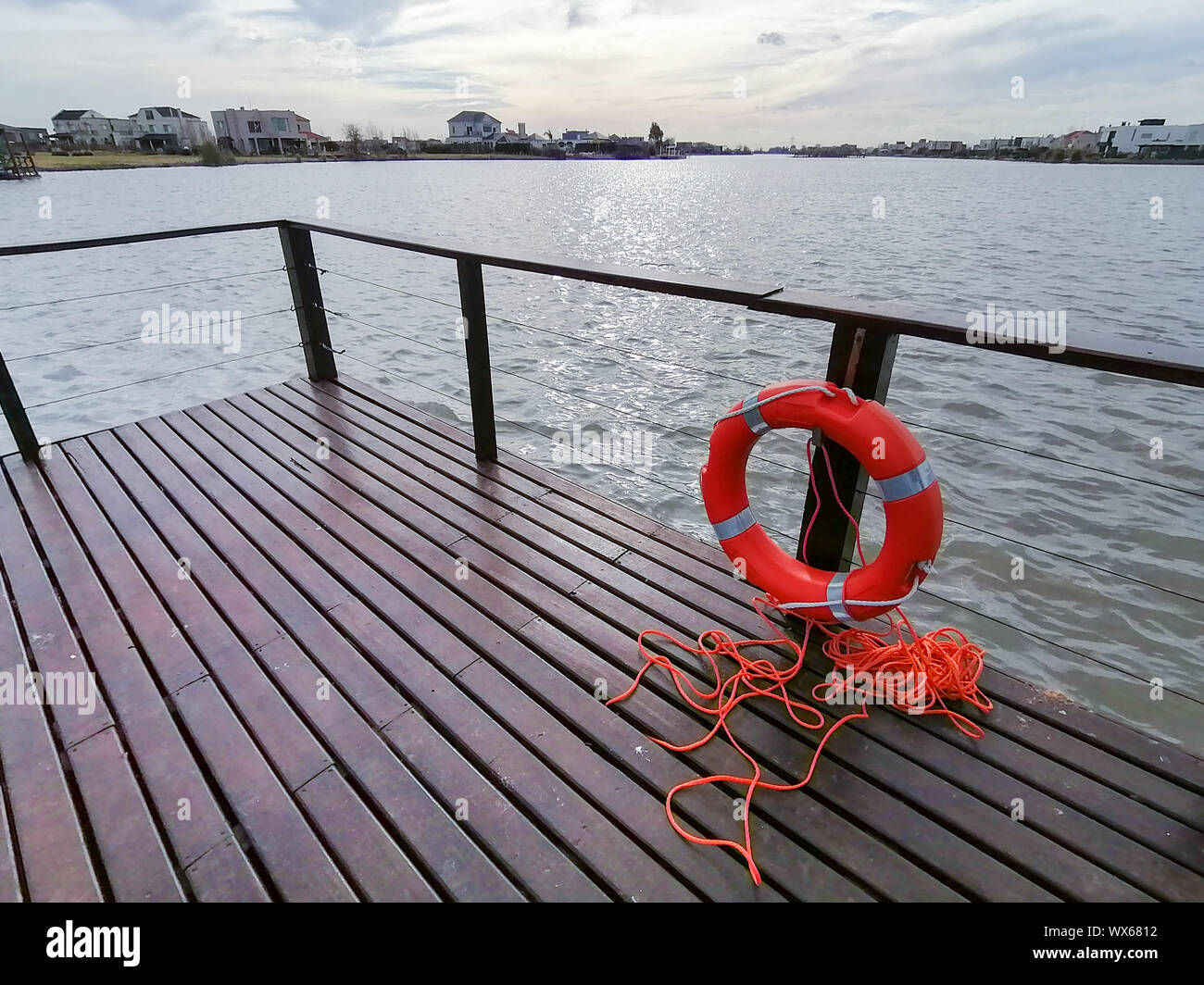 Colorful sky and colorful water in lake from wooden deck pier with ...