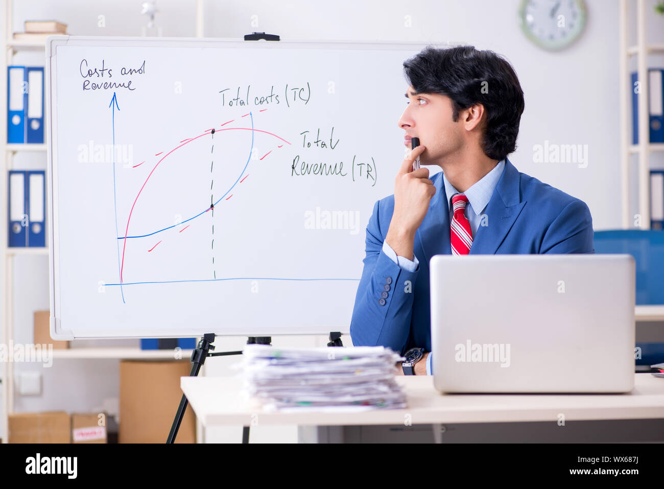 Busy businessman explaining business charts Stock Photo - Alamy