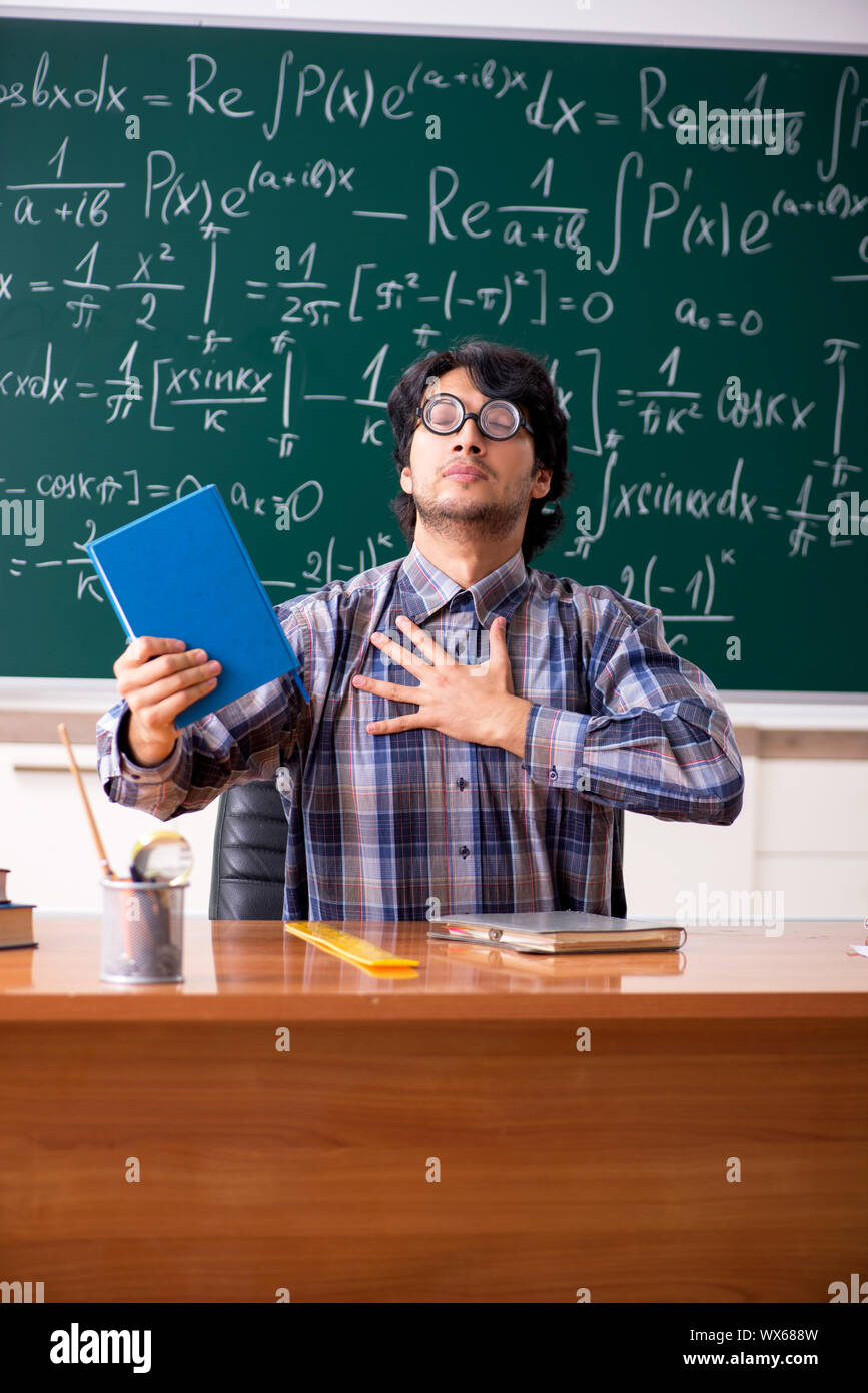 Funny male math teacher in the classroom Stock Photo - Alamy