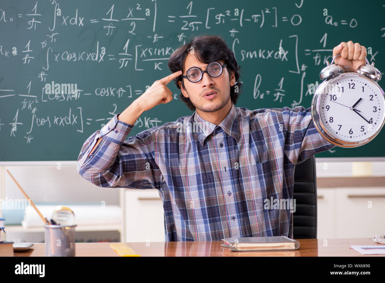 Funny male math teacher in the classroom Stock Photo - Alamy