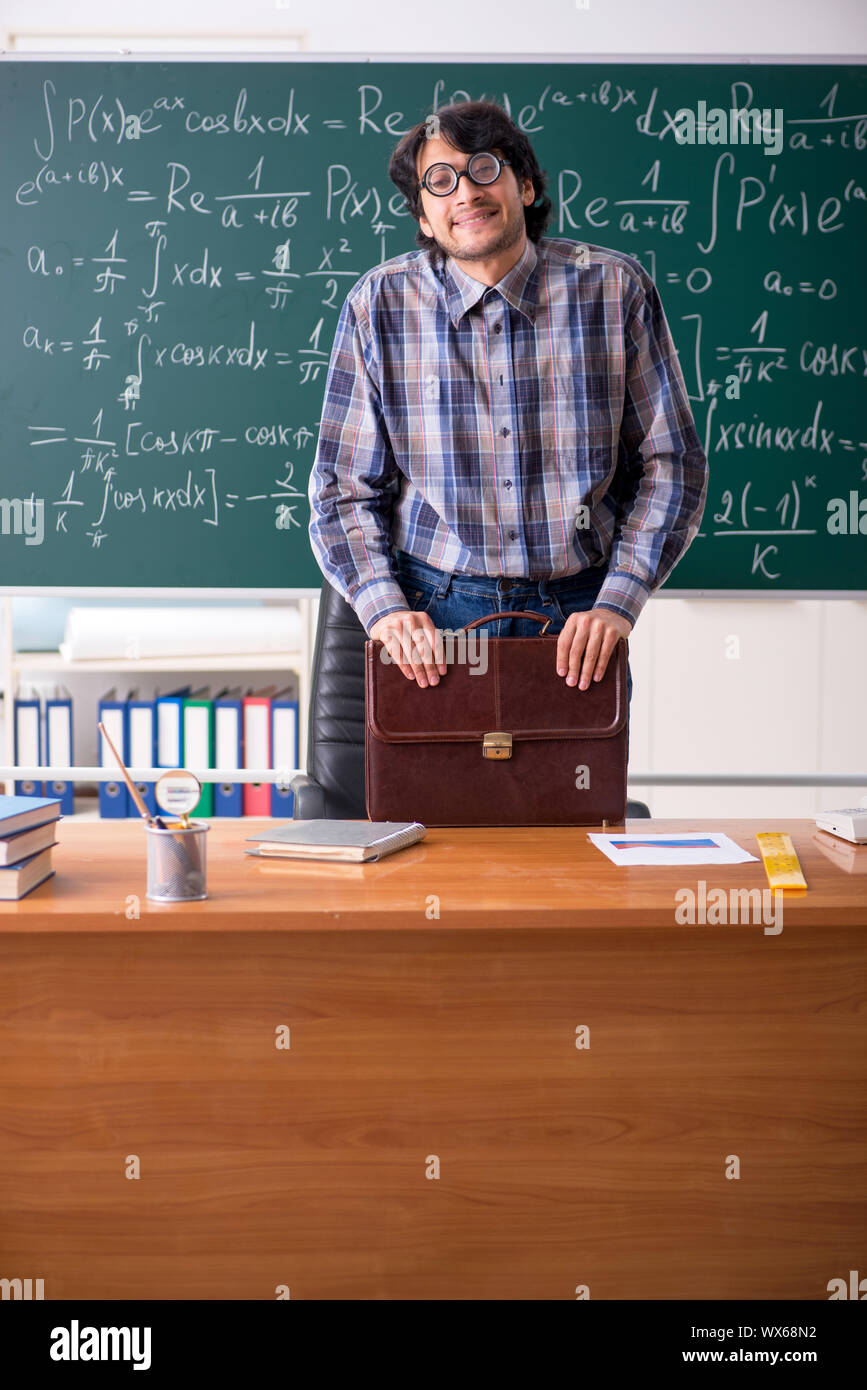 Funny male math teacher in the classroom Stock Photo - Alamy
