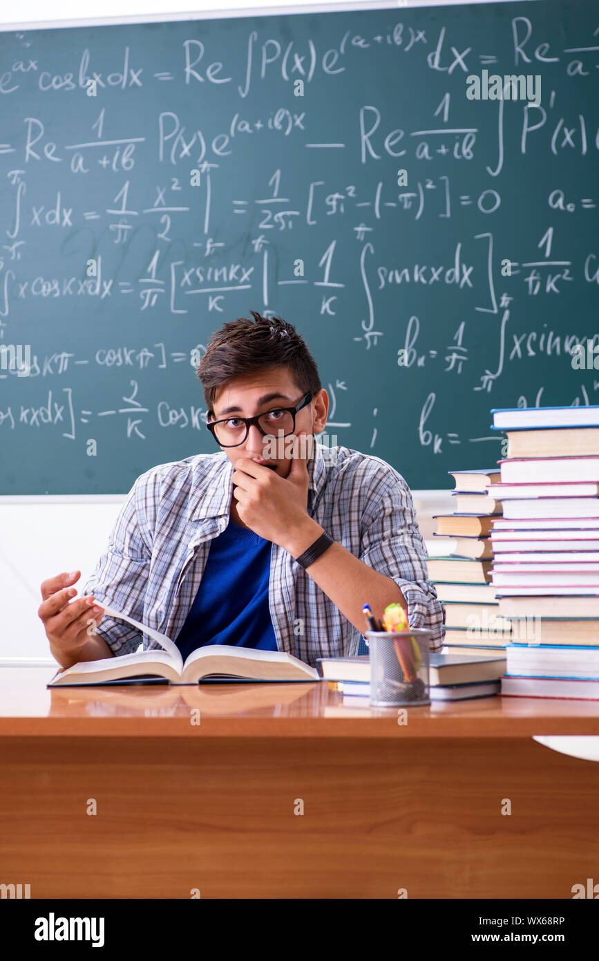 Young male student studying math at school Stock Photo - Alamy