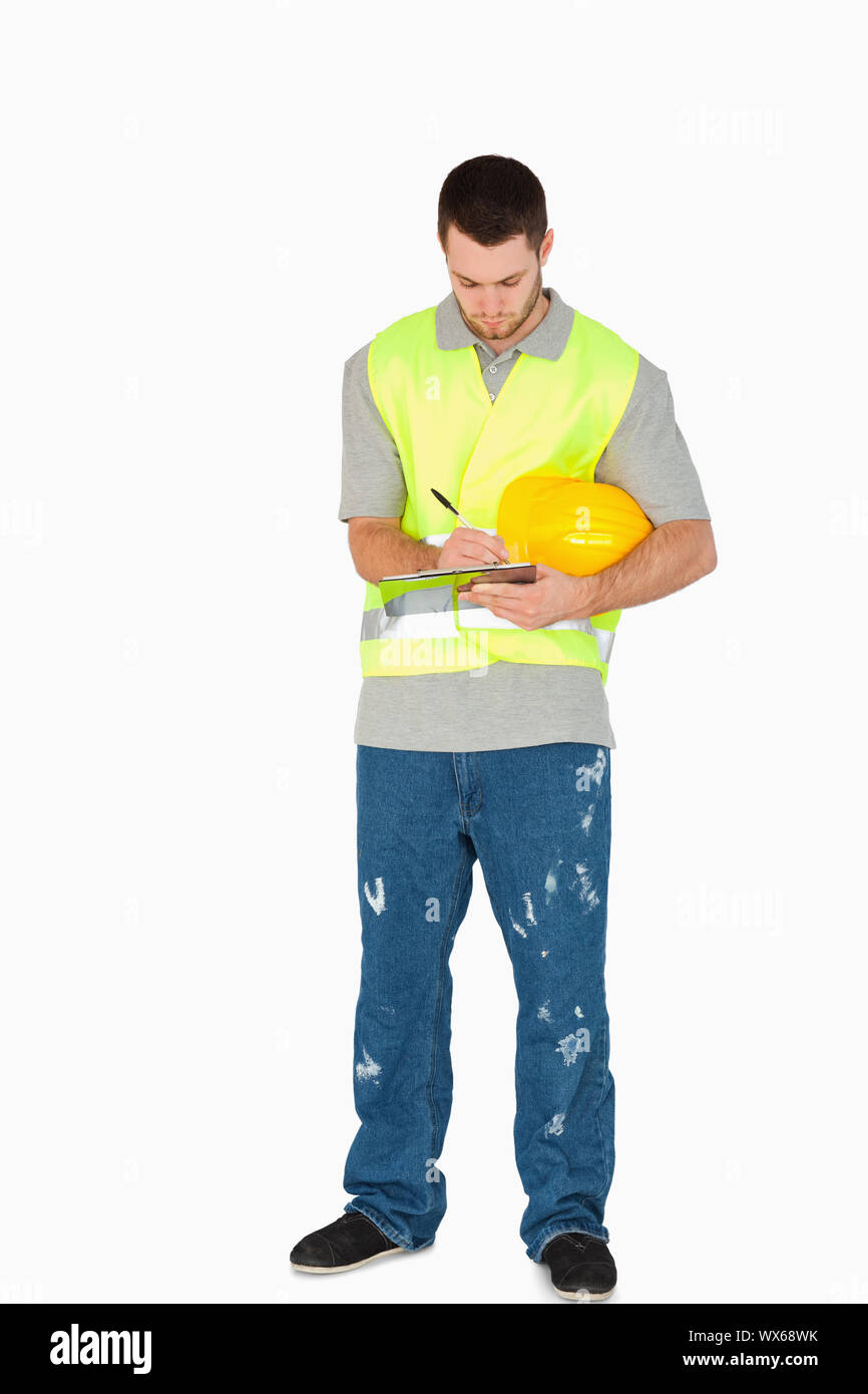 Young construction worker taking notes against a white background Stock ...
