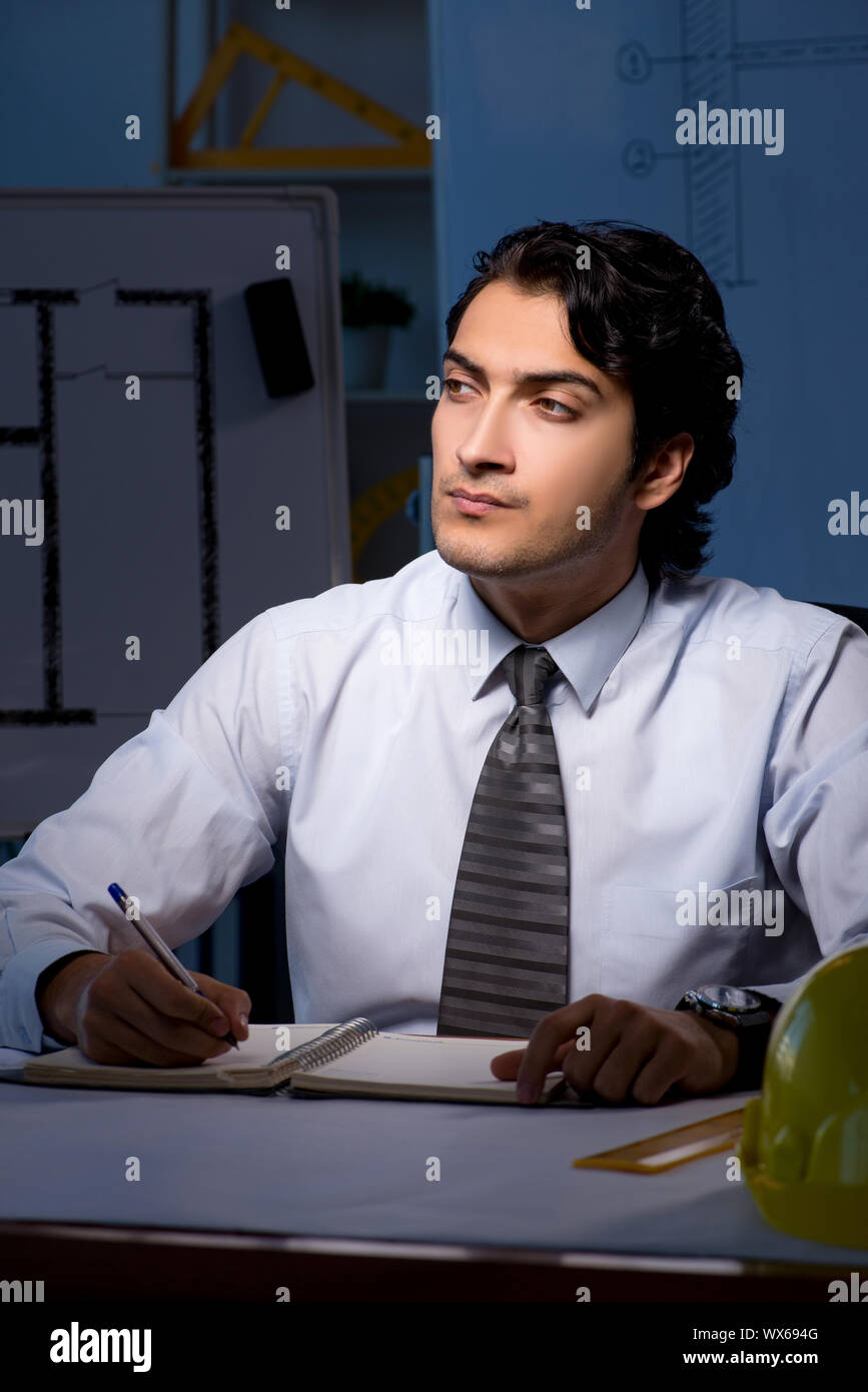 Young construction architect working on project at night Stock Photo ...