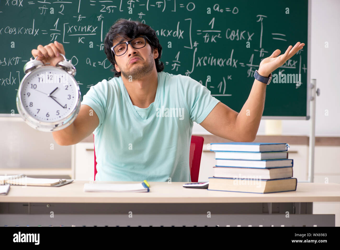 Young male student mathematician in front of chalkboard Stock Photo - Alamy