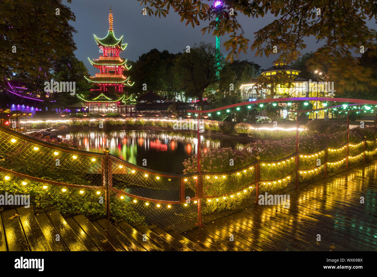The illuminated Tivoli Gardens in Copenhagen by night Stock Photo - Alamy