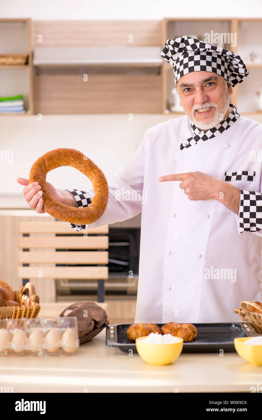 Old male baker working in the kitchen Stock Photo - Alamy