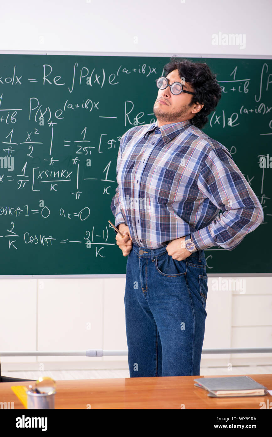 Funny male math teacher in the classroom Stock Photo - Alamy
