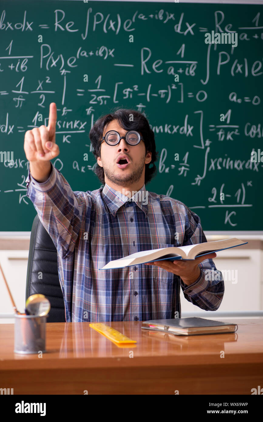 Funny male math teacher in the classroom Stock Photo - Alamy