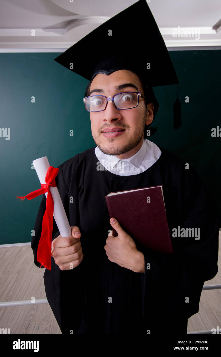 Graduate student in front of green board Stock Photo - Alamy