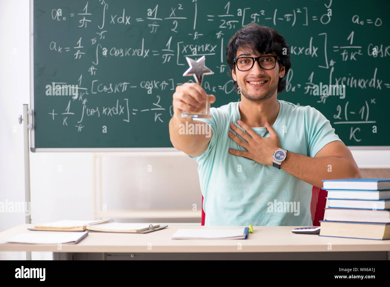 Young male student mathematician in front of chalkboard Stock Photo - Alamy