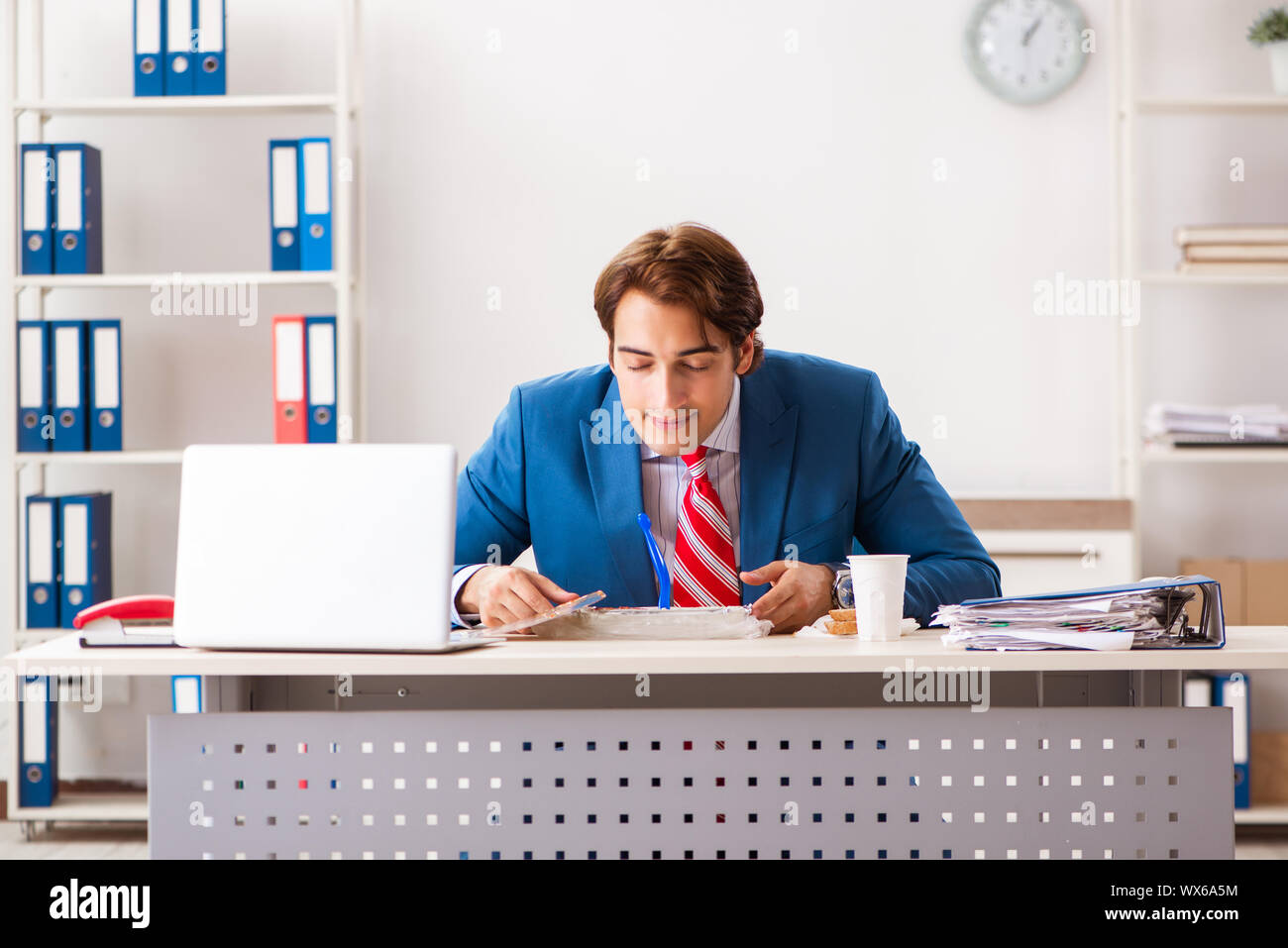 Man having meal at work during break Stock Photo - Alamy