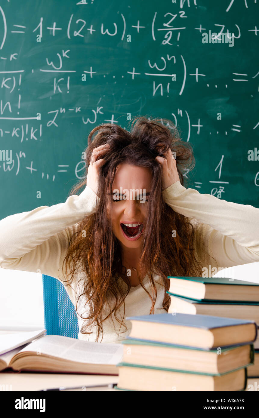 Young female math teacher in front of chalkboard Stock Photo - Alamy