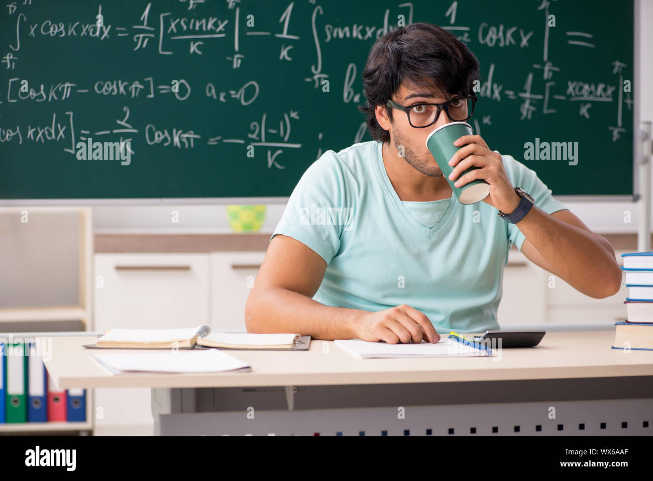 Young male student mathematician in front of chalkboard Stock Photo - Alamy