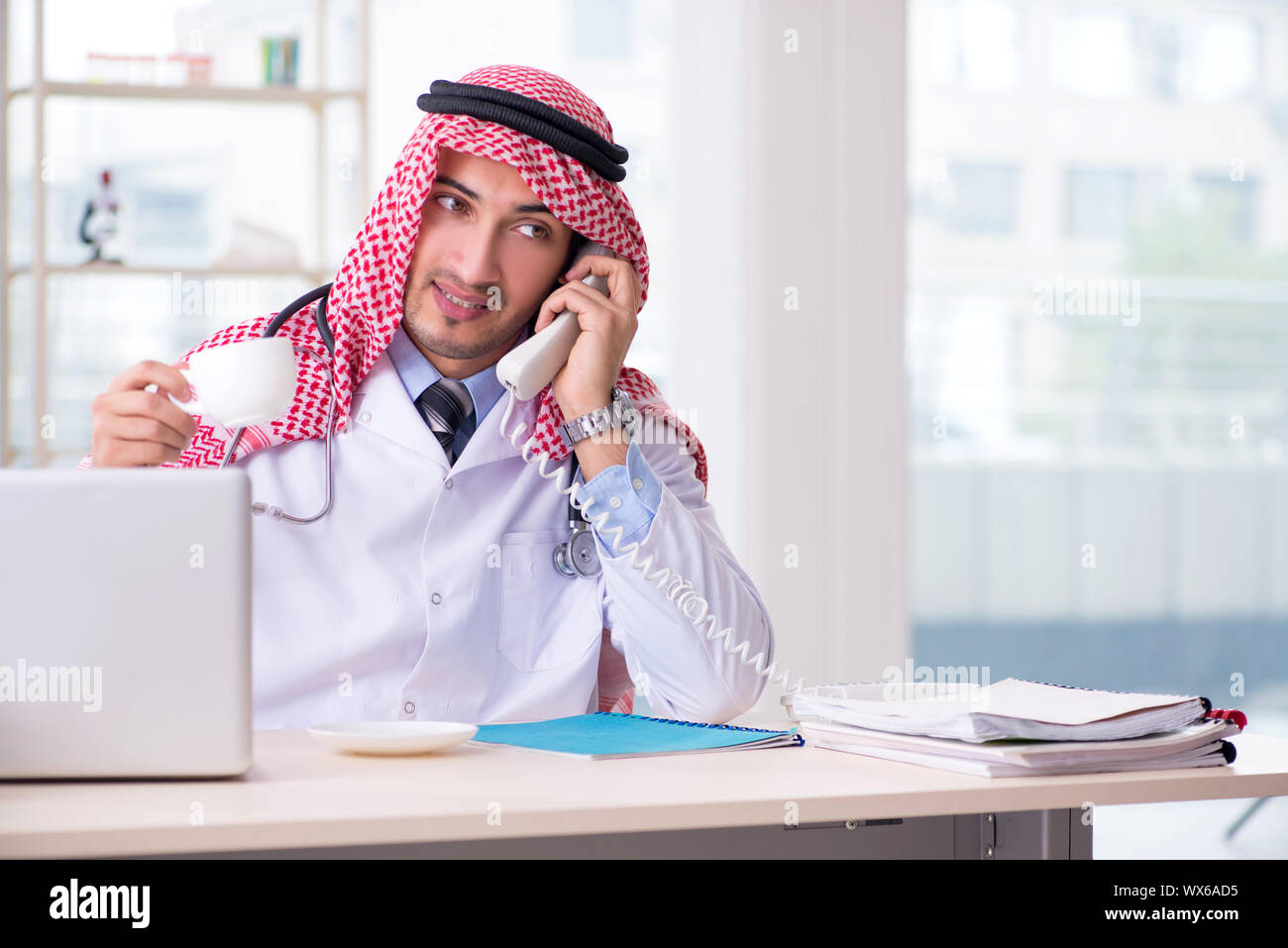 Arab doctor working in the clinic Stock Photo - Alamy
