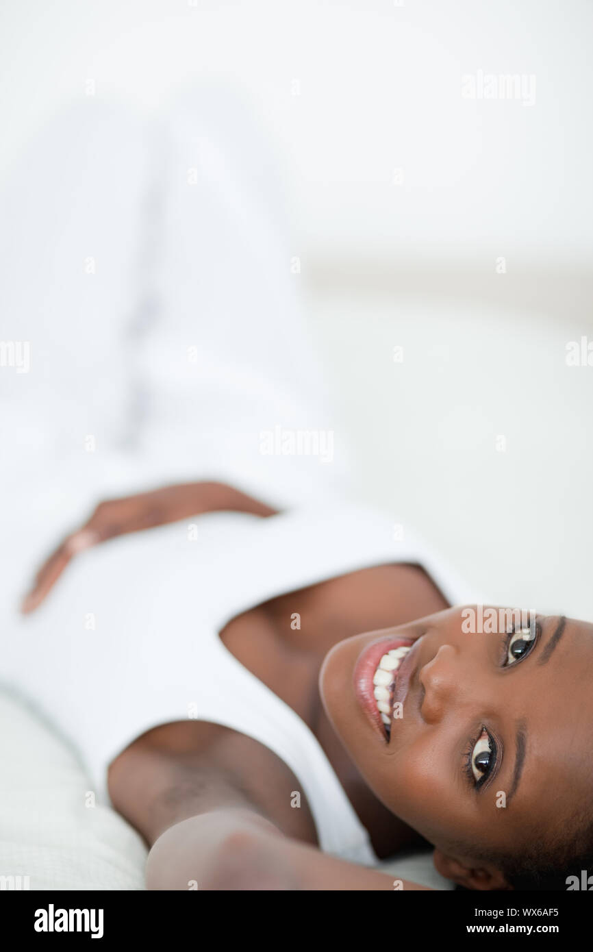 Portrait of a woman lying on her back in her bedroom Stock Photo - Alamy