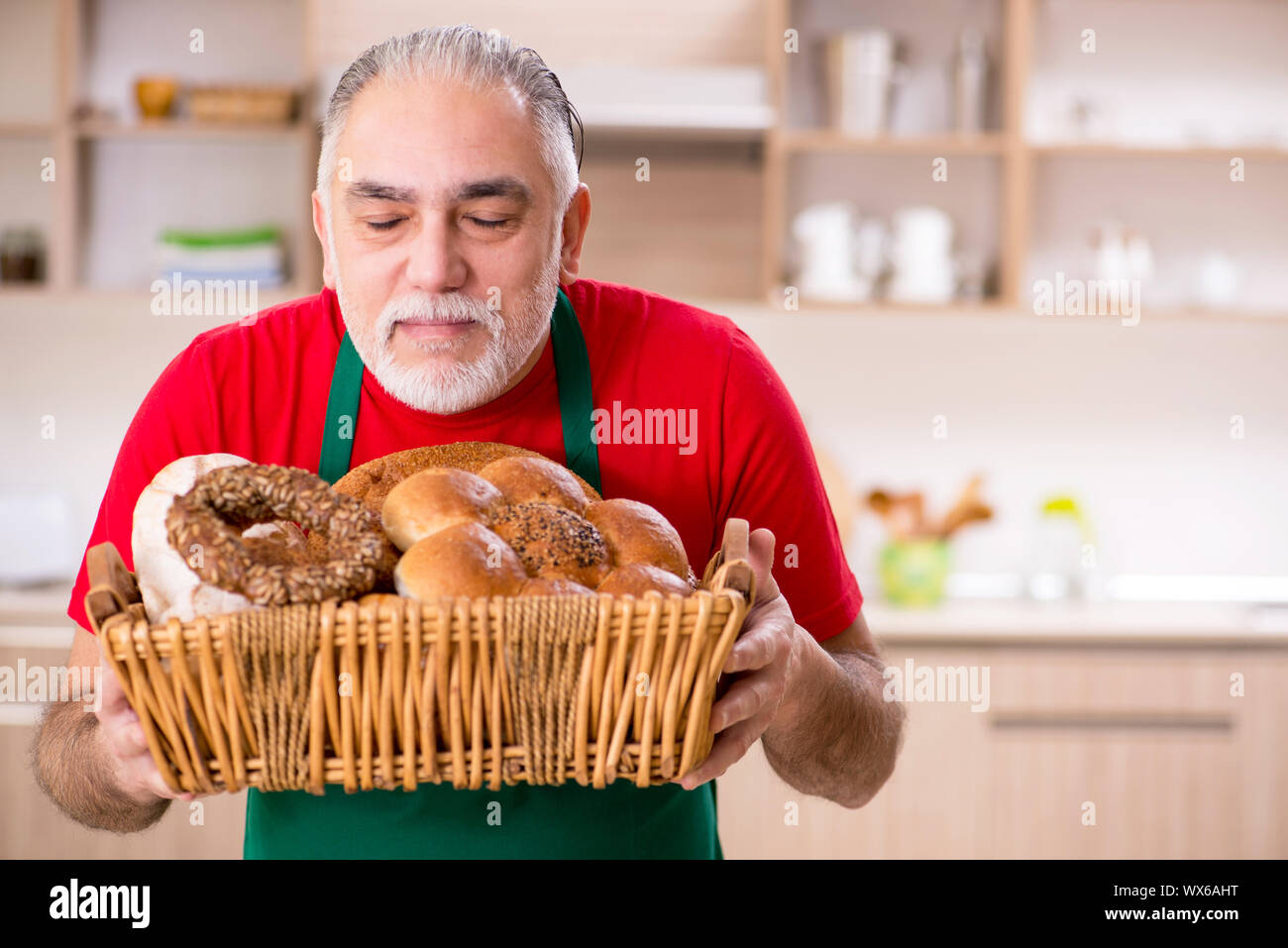 Old male baker working in the kitchen Stock Photo - Alamy