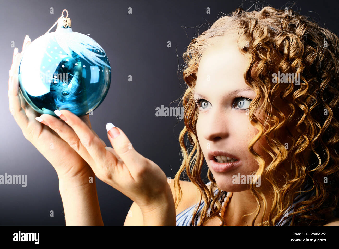 The girl with a magic New Year's sphere is very surprised holidays ...