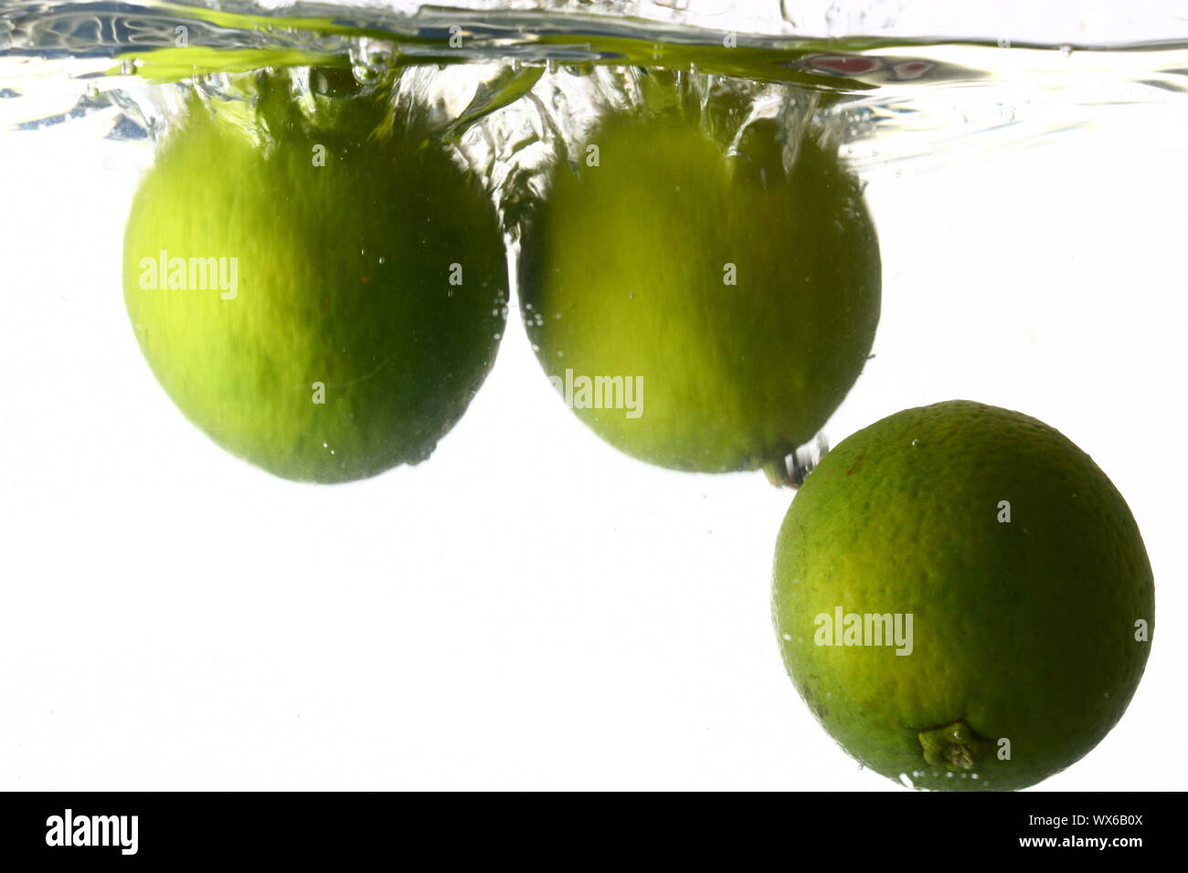lime splash isolated on white background Stock Photo - Alamy