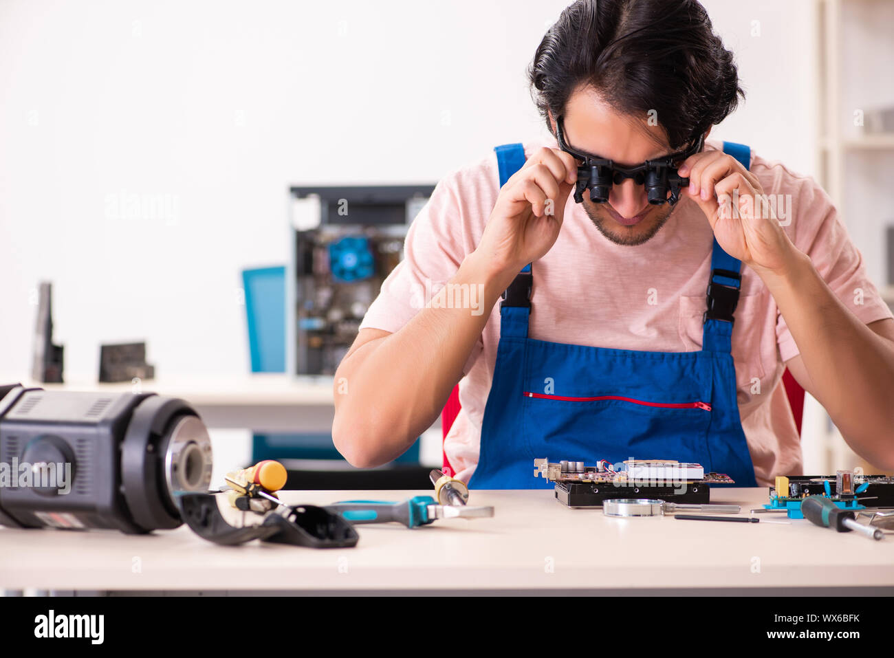 Young Male Contractor Repairing Computer Stock Photo - Alamy