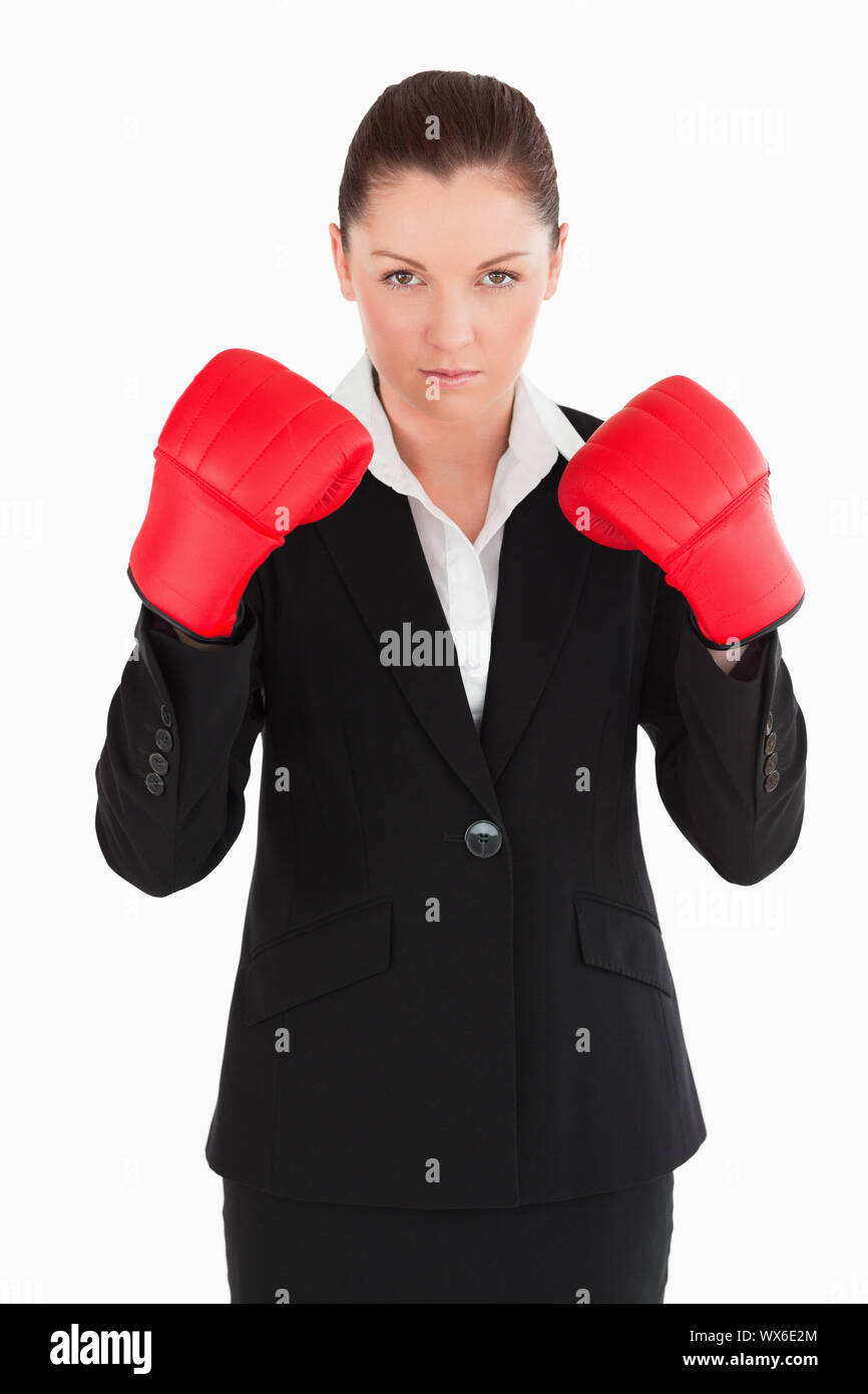 Charming woman wearing some boxing gloves while standing against a ...