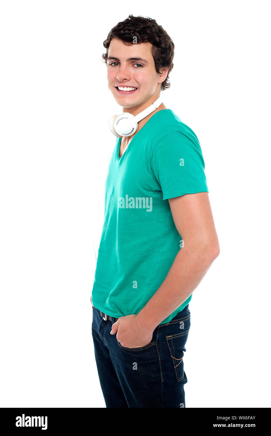 Side view, profile shot of smart casual guy. Headphones around his neck ...