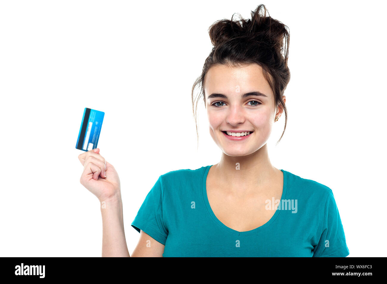 Smiling cute girl posing with her credit card isolated against white ...