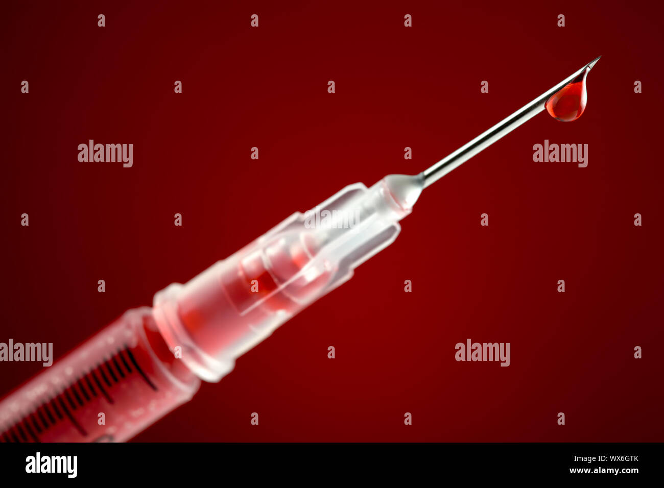 Sharp syringe leaking blood Stock Photo - Alamy