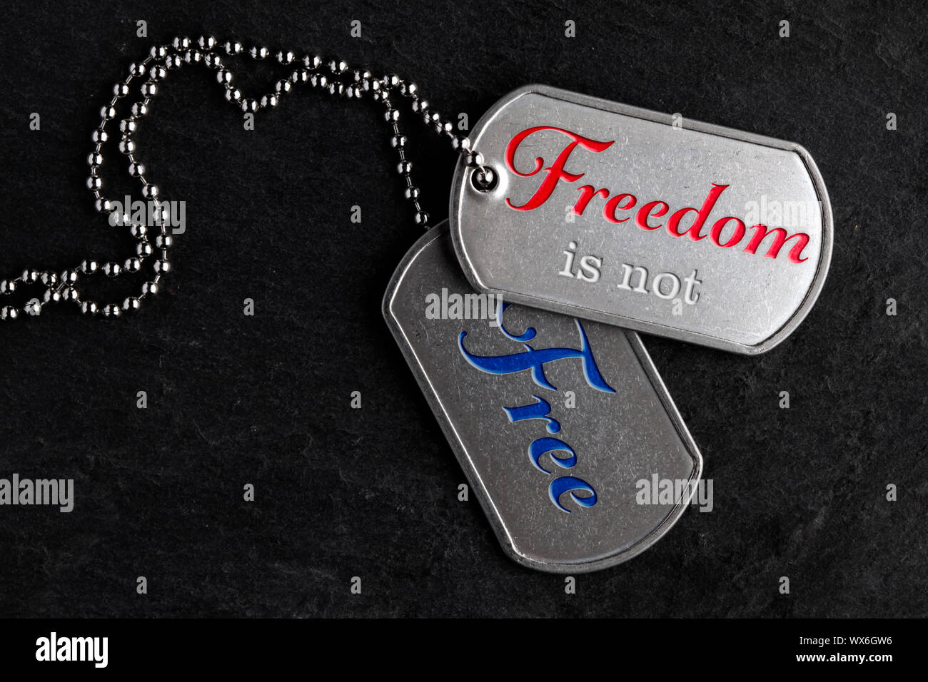 Old and worn military dog tags - Freedom is not Free Stock Photo - Alamy