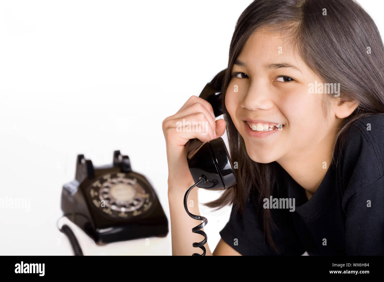 Young girl talking on old fashioned phone Stock Photo - Alamy