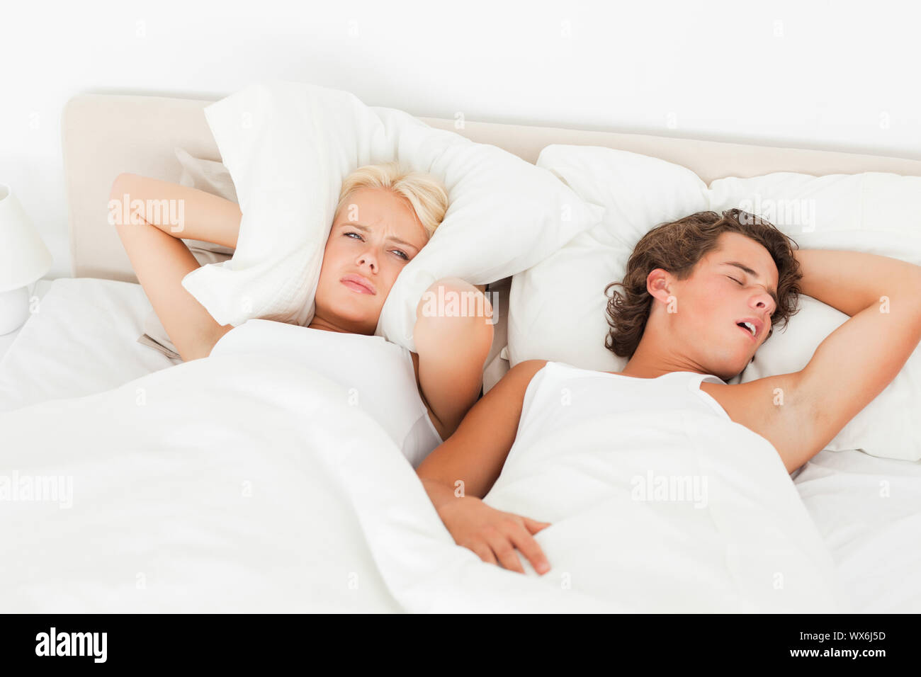 Young couple waking up in their bedroom Stock Photo - Alamy