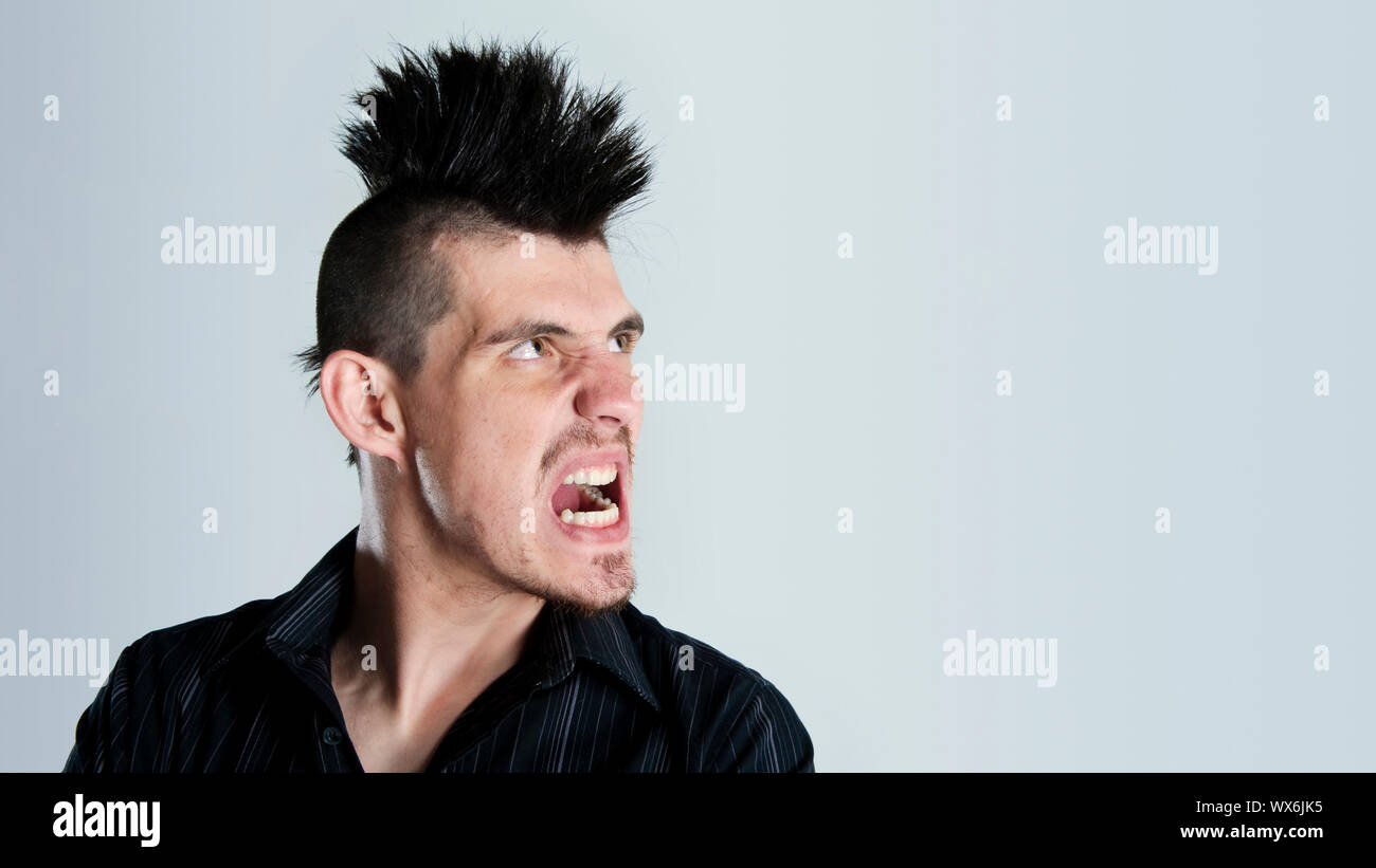 Man is super angry and sports a mohawk haircut Stock Photo - Alamy