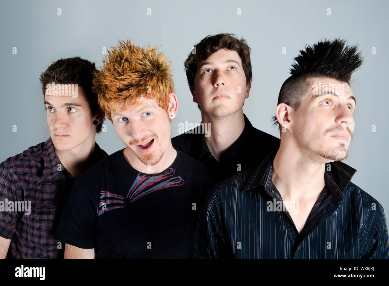 Alternative guys stand together and look in different directions Stock ...