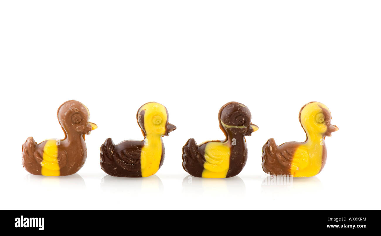 chocolate ducks in a row isolated over white Stock Photo - Alamy