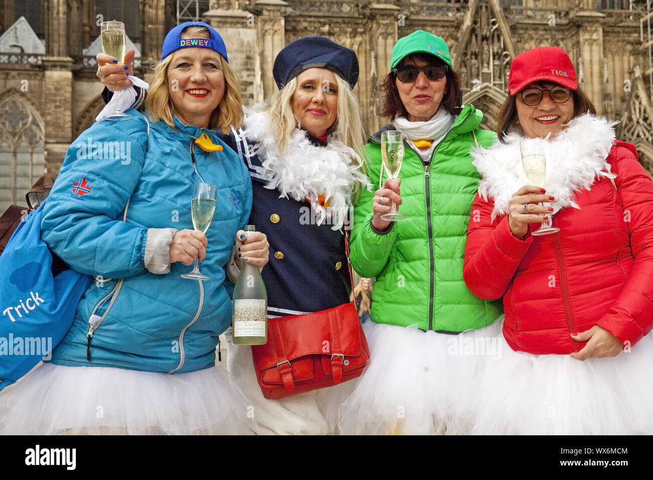 Four women at Weiberfastnacht in front of the cathedral, Cologne ...