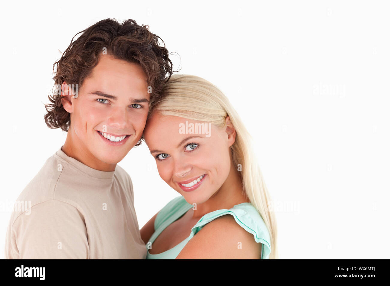 Portrait of a hugging couple in a studio Stock Photo - Alamy