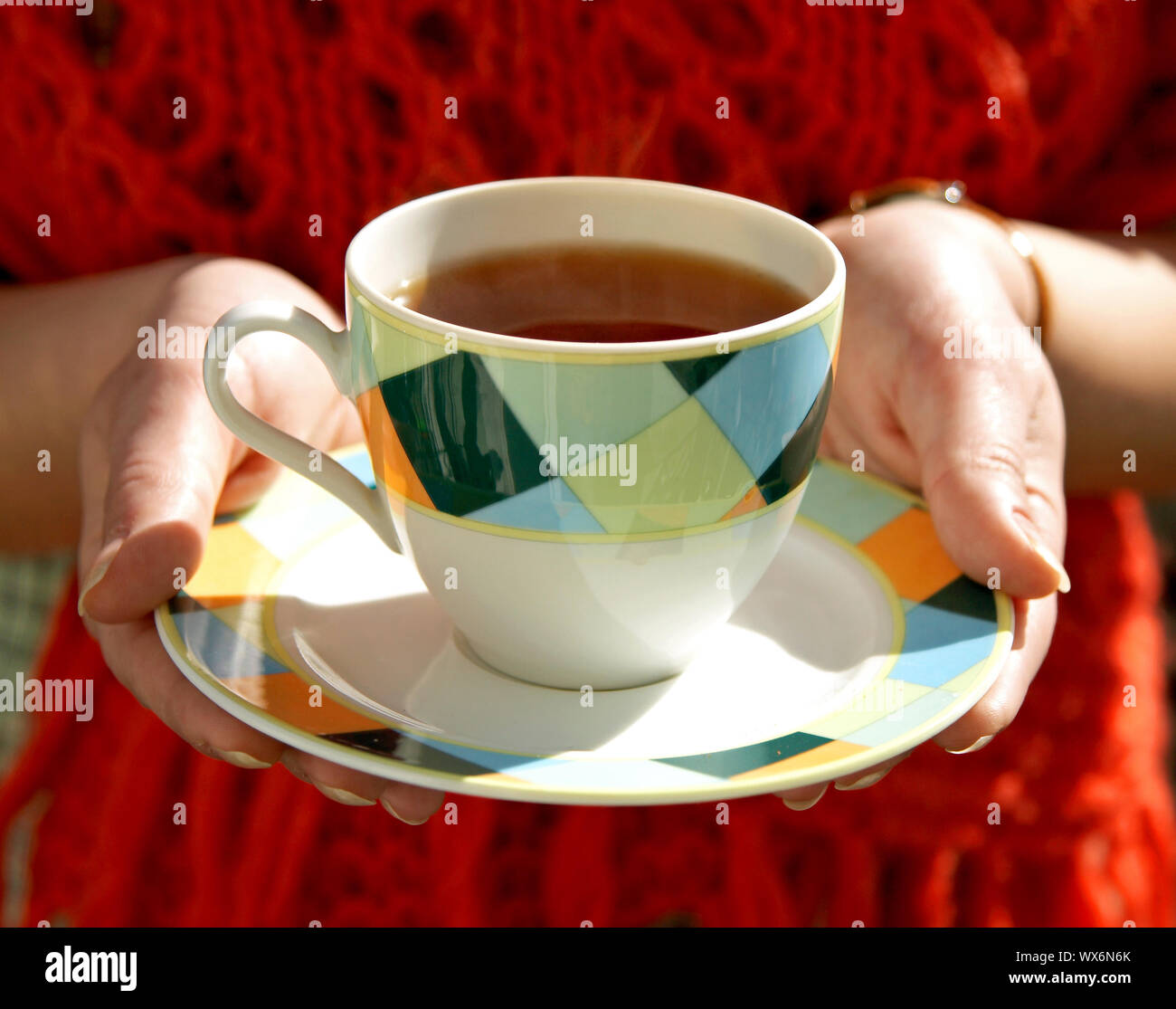 cup of tea in hands of woman Stock Photo - Alamy