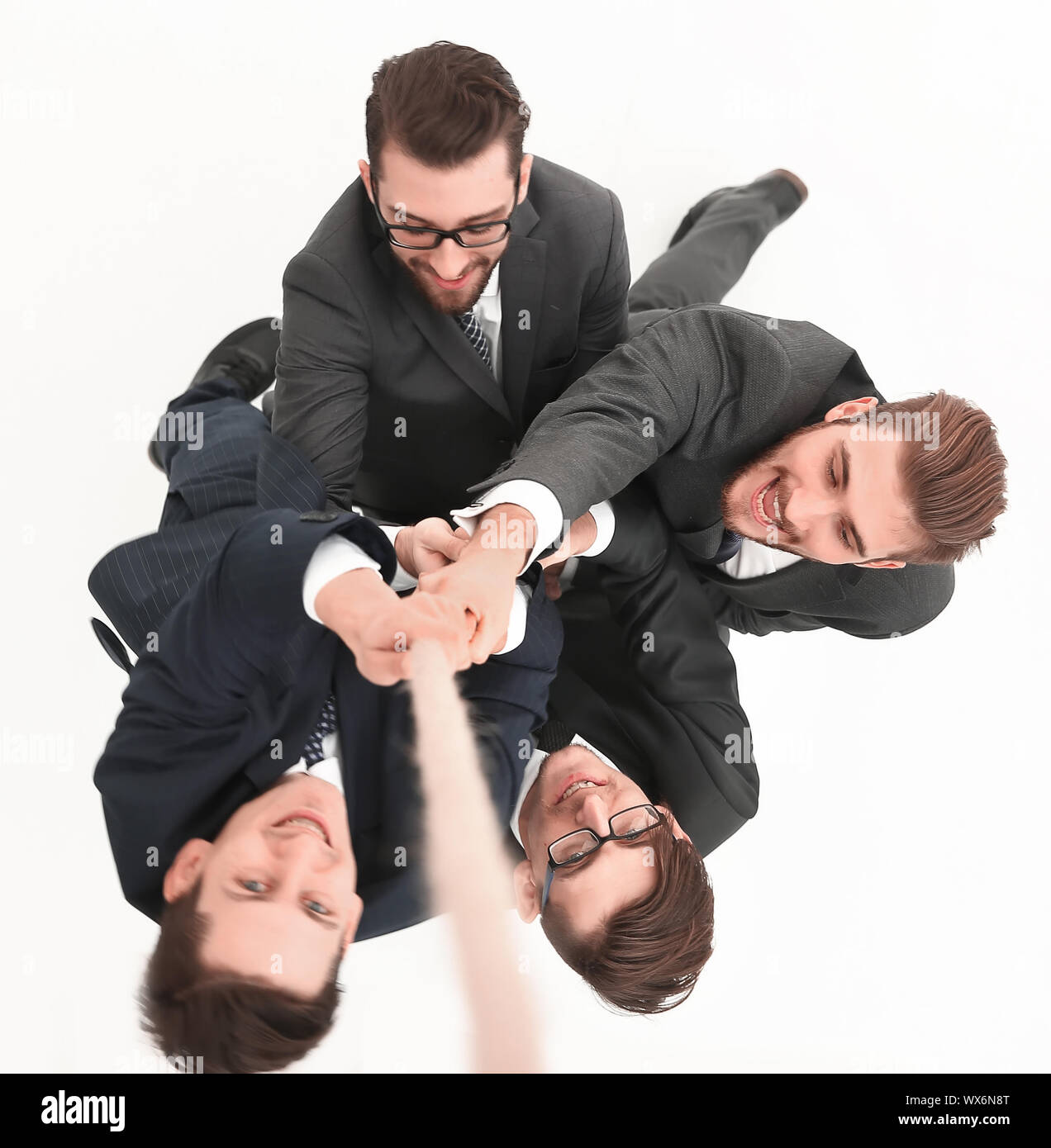 smiling business team holding the rope Stock Photo - Alamy